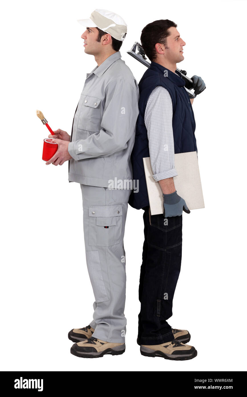 Painter and tiler stood back to back Stock Photo - Alamy