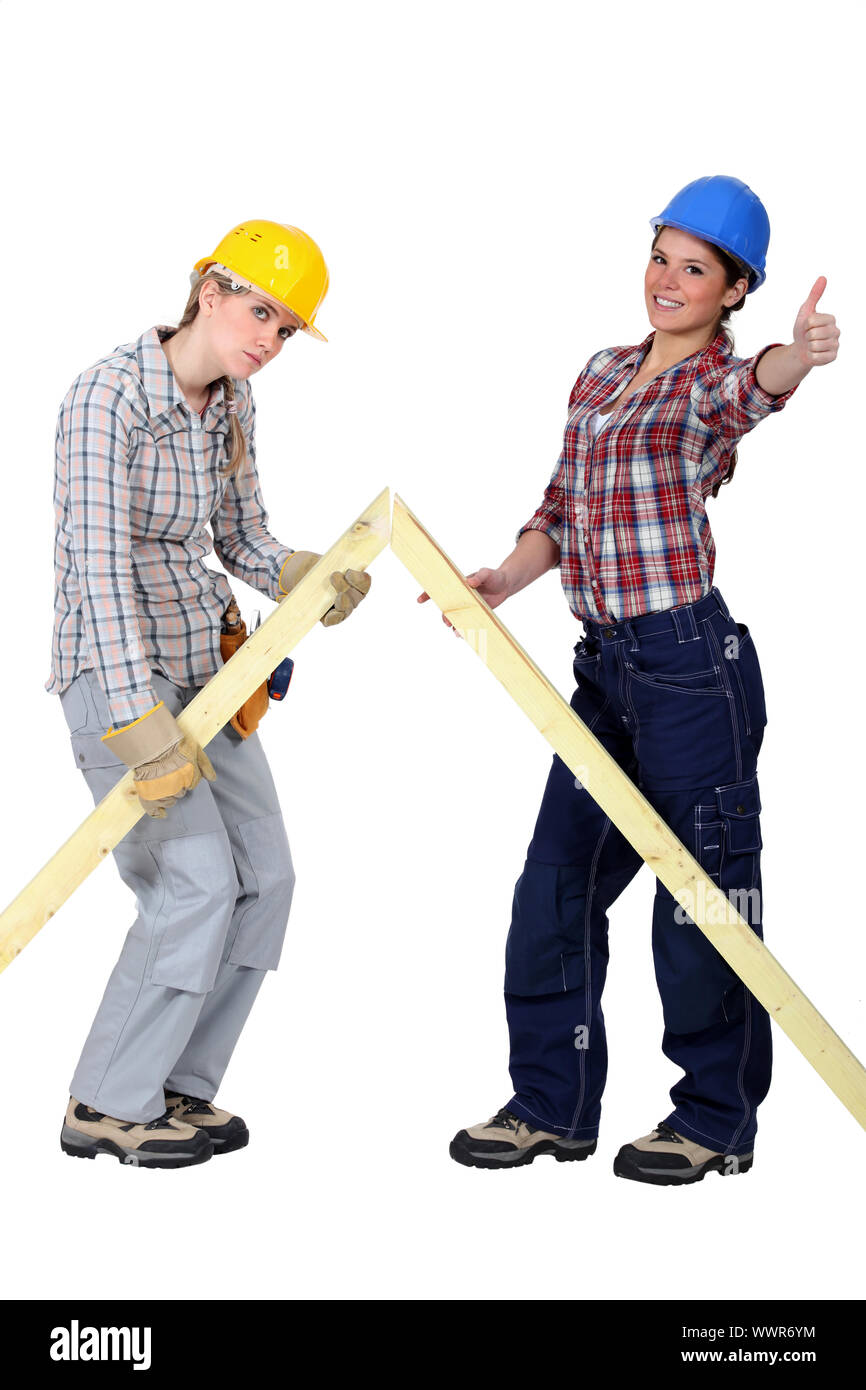 Female carpenters making wooden frame Stock Photo - Alamy