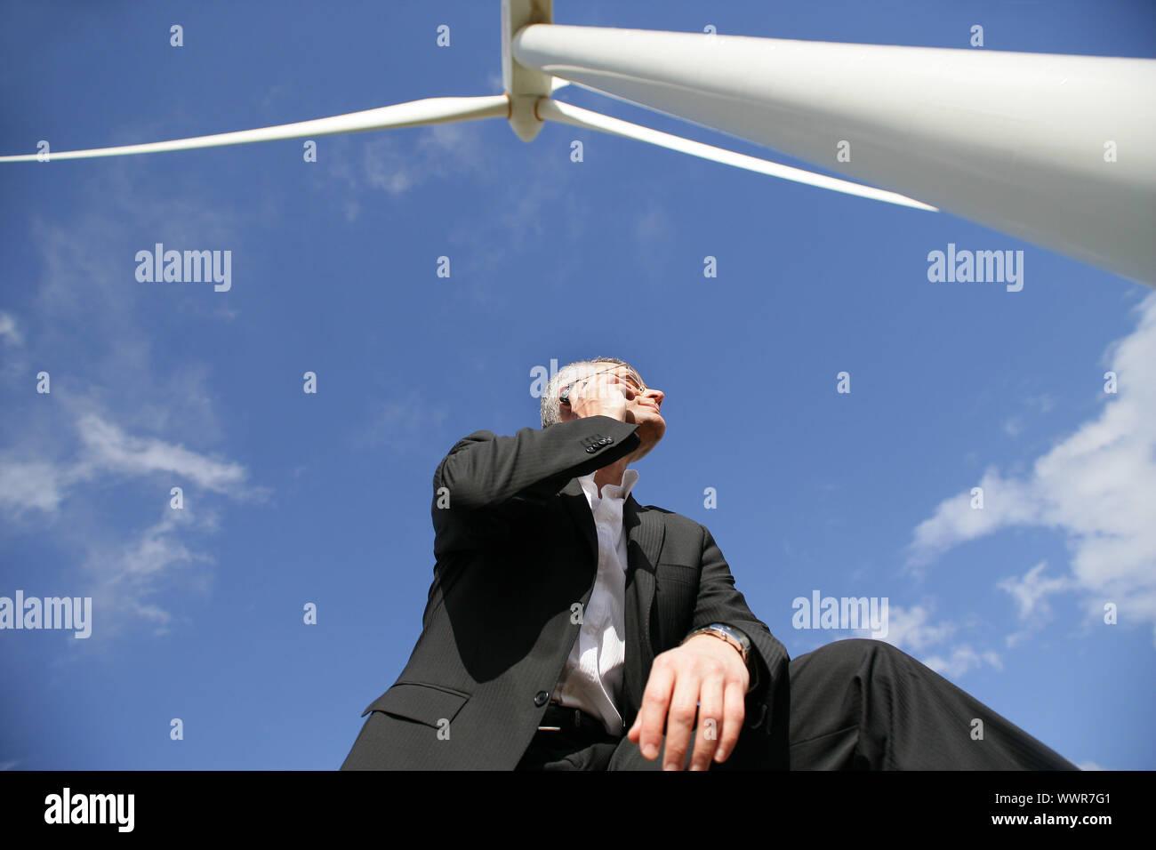 Man near wind turbine Stock Photo - Alamy