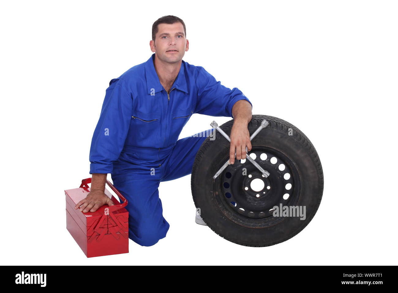 Mechanic with wheel Stock Photo - Alamy