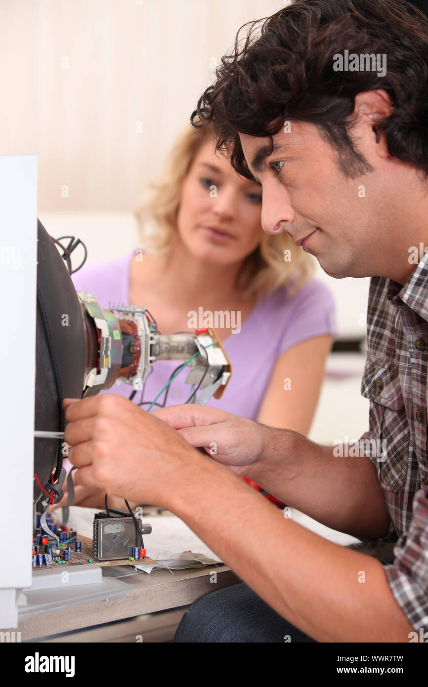 Fixing the TV Stock Photo - Alamy