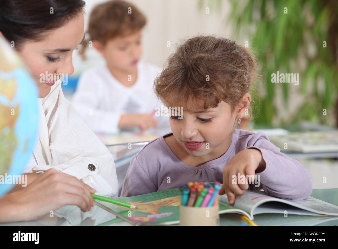 Teacher with a little girl Stock Photo - Alamy