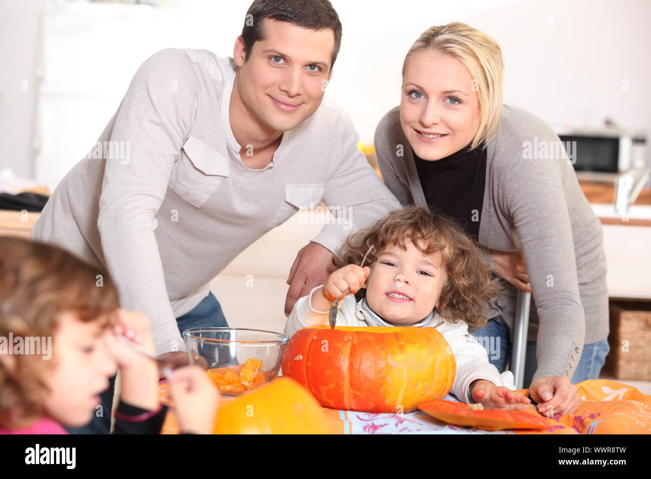 Family carving pumpkins together Stock Photo - Alamy