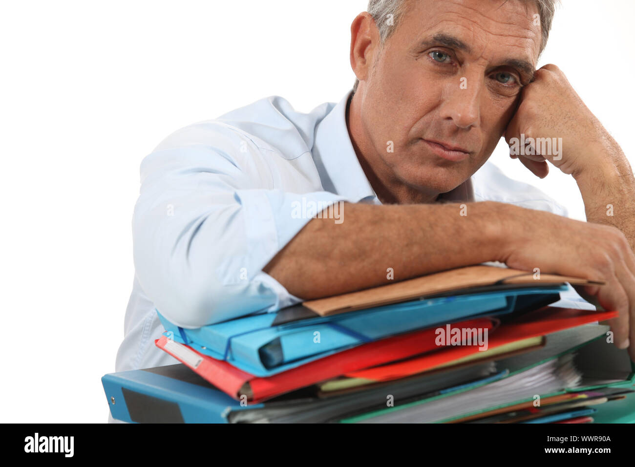 Man leaning on stack of work Stock Photo - Alamy