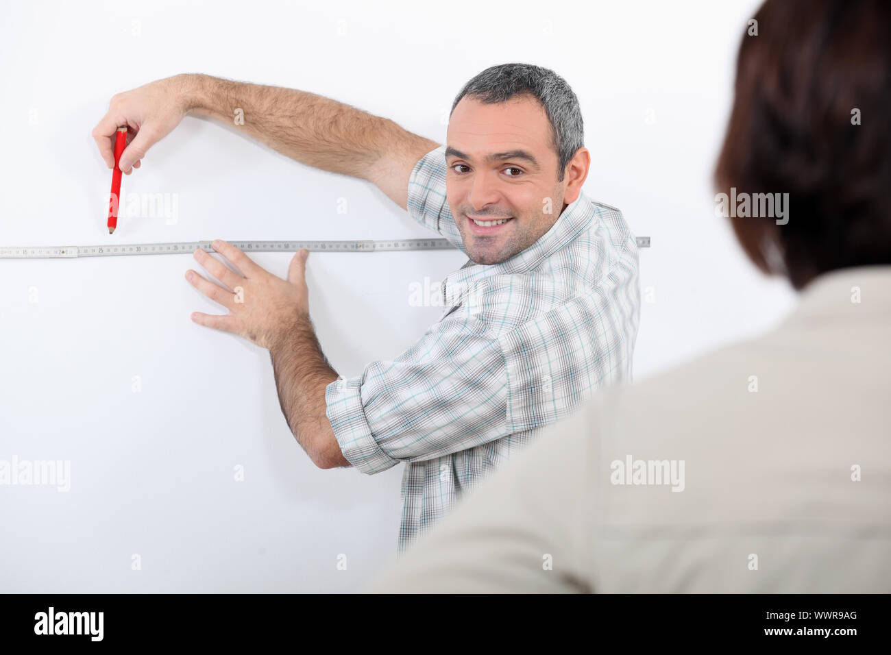 Man drawing line on wall Stock Photo - Alamy