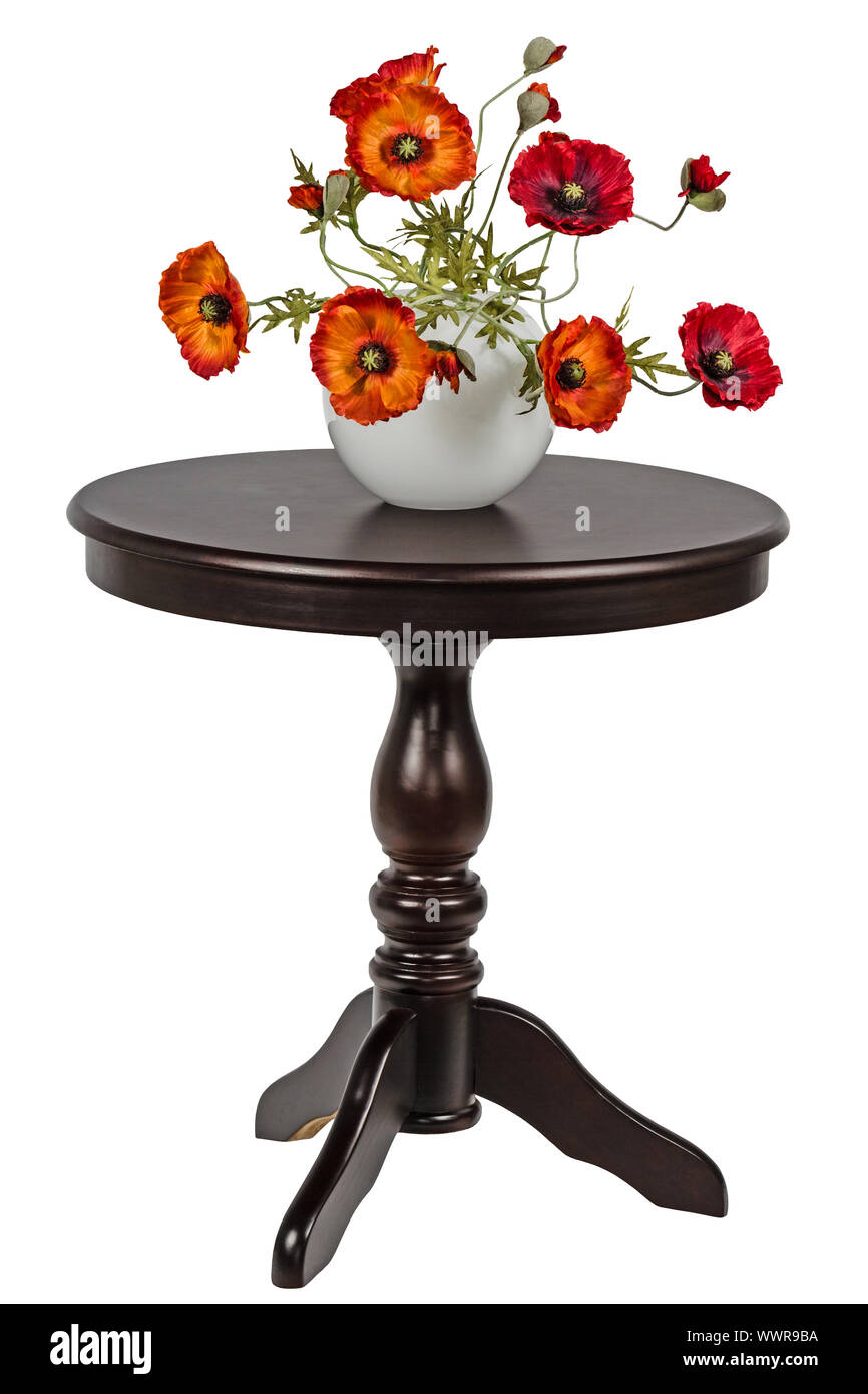 Bouquet of artificial poppies in a vase on the round table, isolated on ...