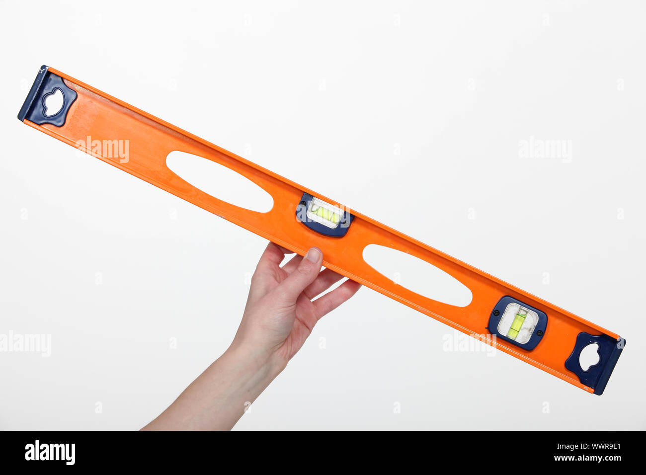 Hand holding a spirit level isolated on white background Stock Photo ...