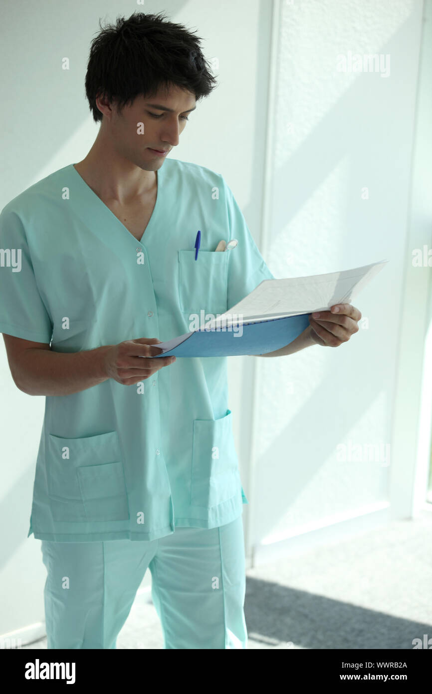 Nurse reading notes Stock Photo - Alamy