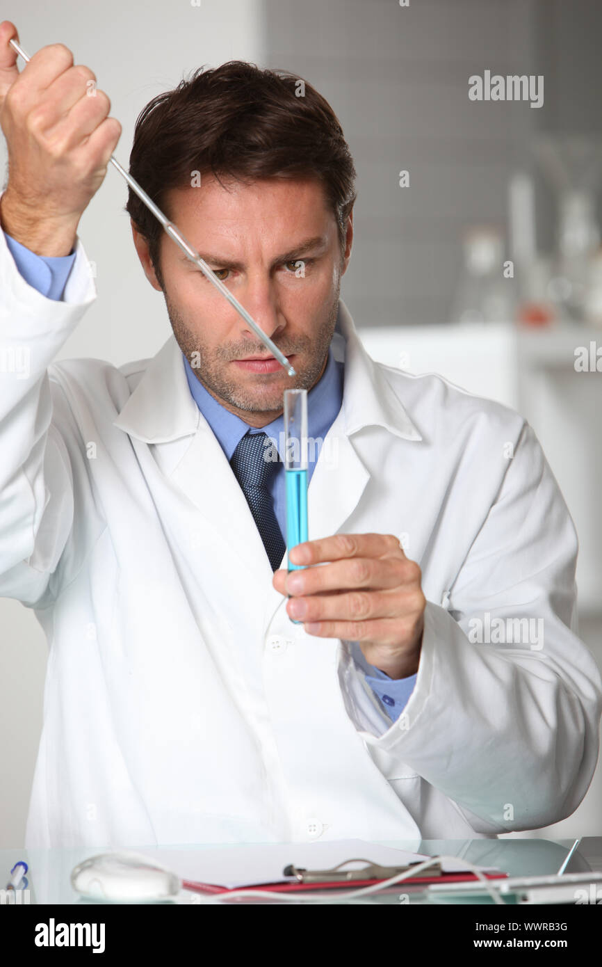 Laboratory technician working with a test tube Stock Photo - Alamy