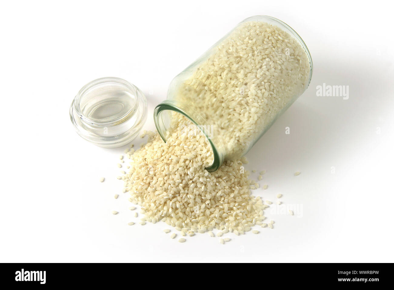 Rice spilling from jar Stock Photo - Alamy
