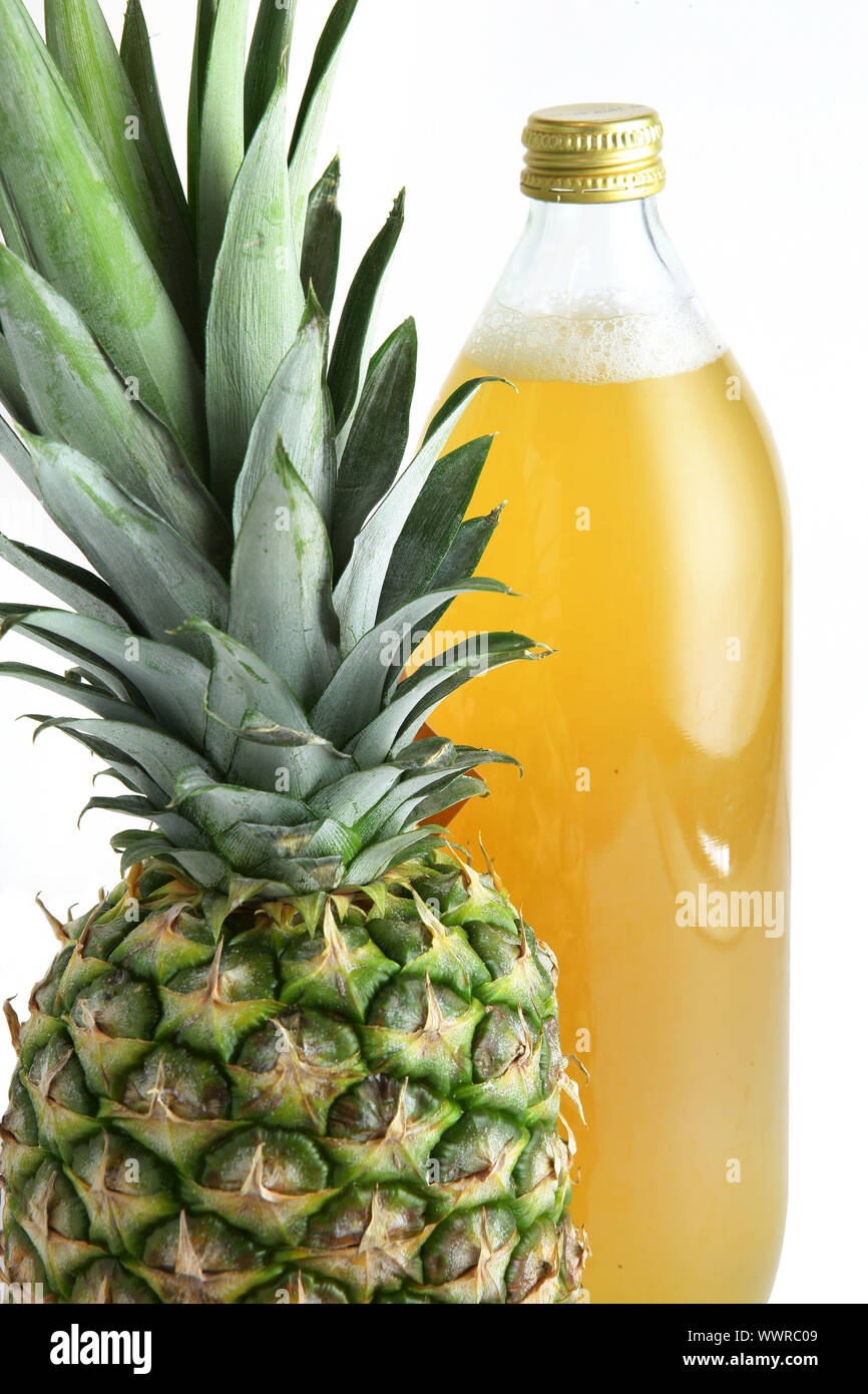 Pineapple and a bottle of juice Stock Photo - Alamy