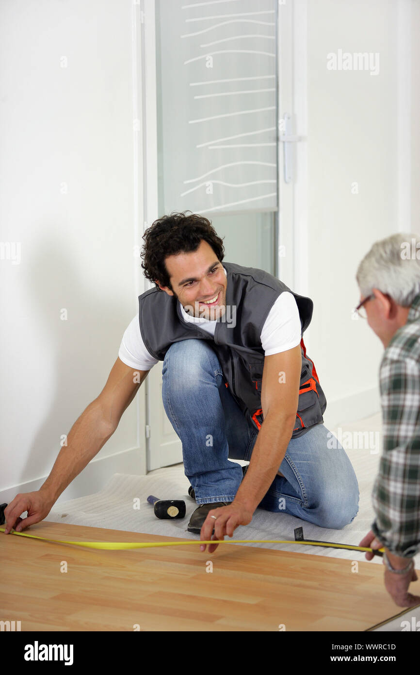 Man measuring flooring Stock Photo - Alamy