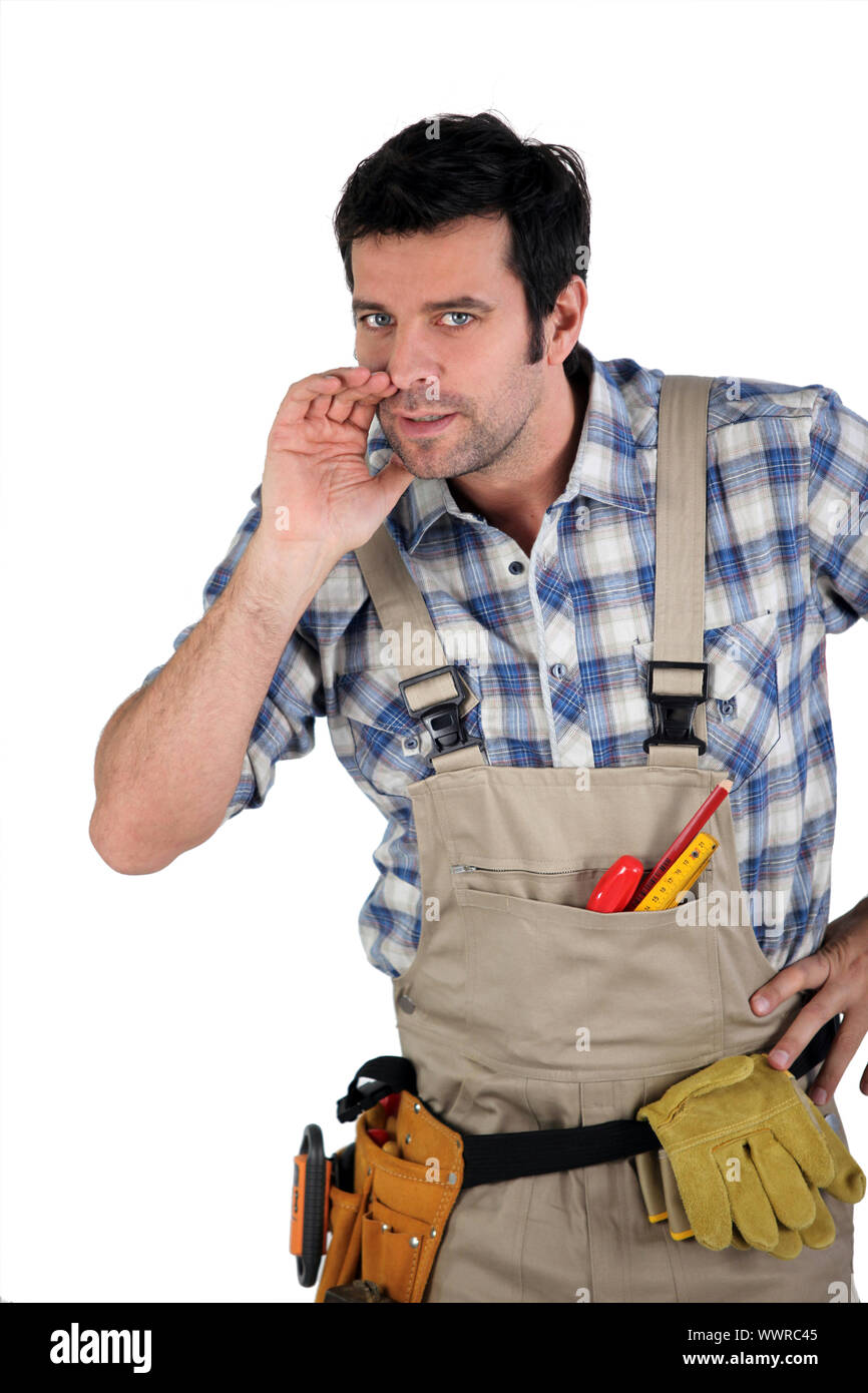 Handyman whispering on white background Stock Photo - Alamy