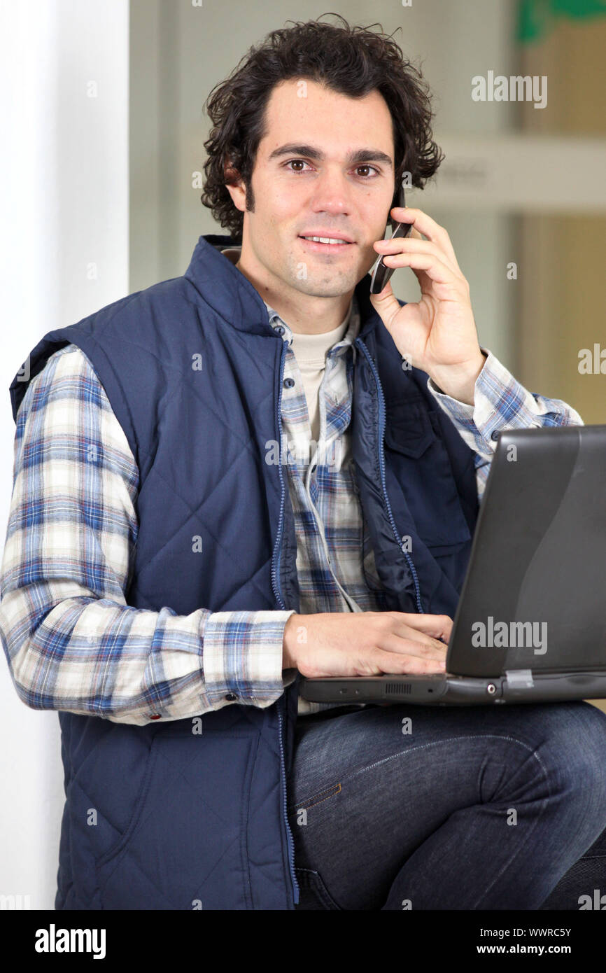 craftsman taking on his cell phone Stock Photo - Alamy