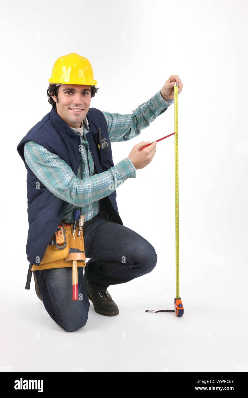 Builder measuring height tape measure hi-res stock photography and ...