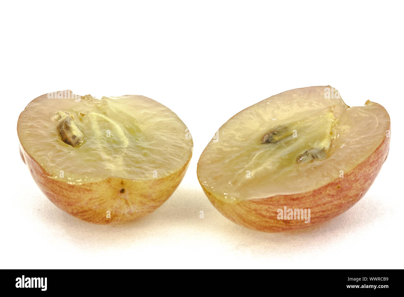 Half of the fruit of the grapes close-up, isolated on white background ...