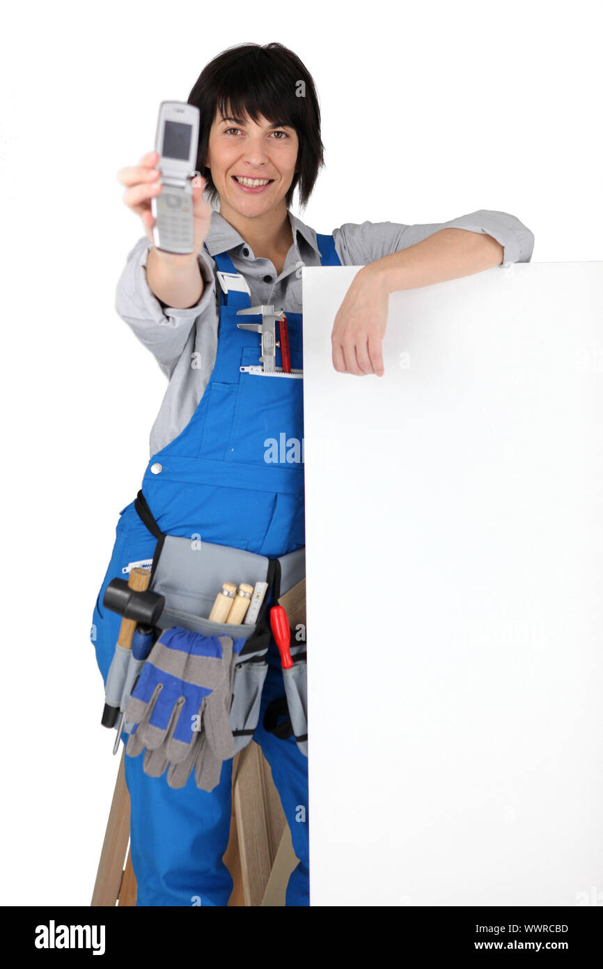 Female manual worker displaying mobile telephone Stock Photo - Alamy