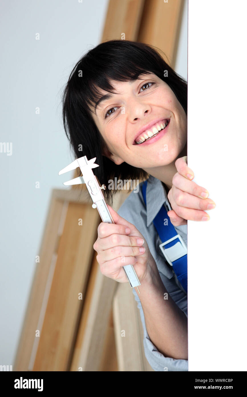 Woman holding calipers Stock Photo - Alamy