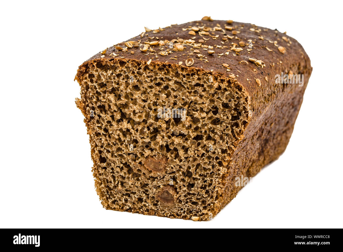 Cut in half a loaf of bread made of dark flour, isolated on white ...