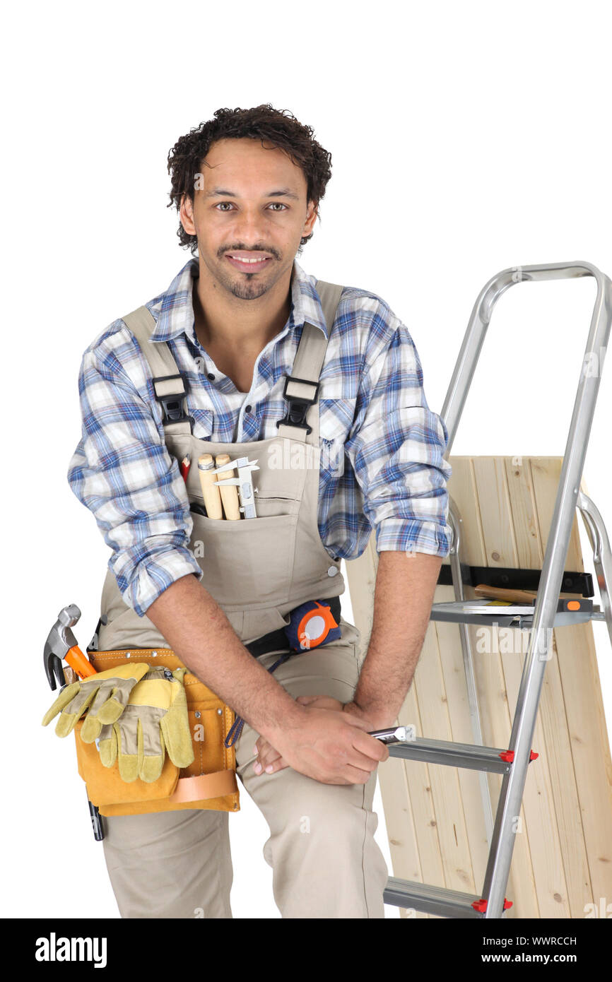 Carpenter stood by step-ladder Stock Photo - Alamy
