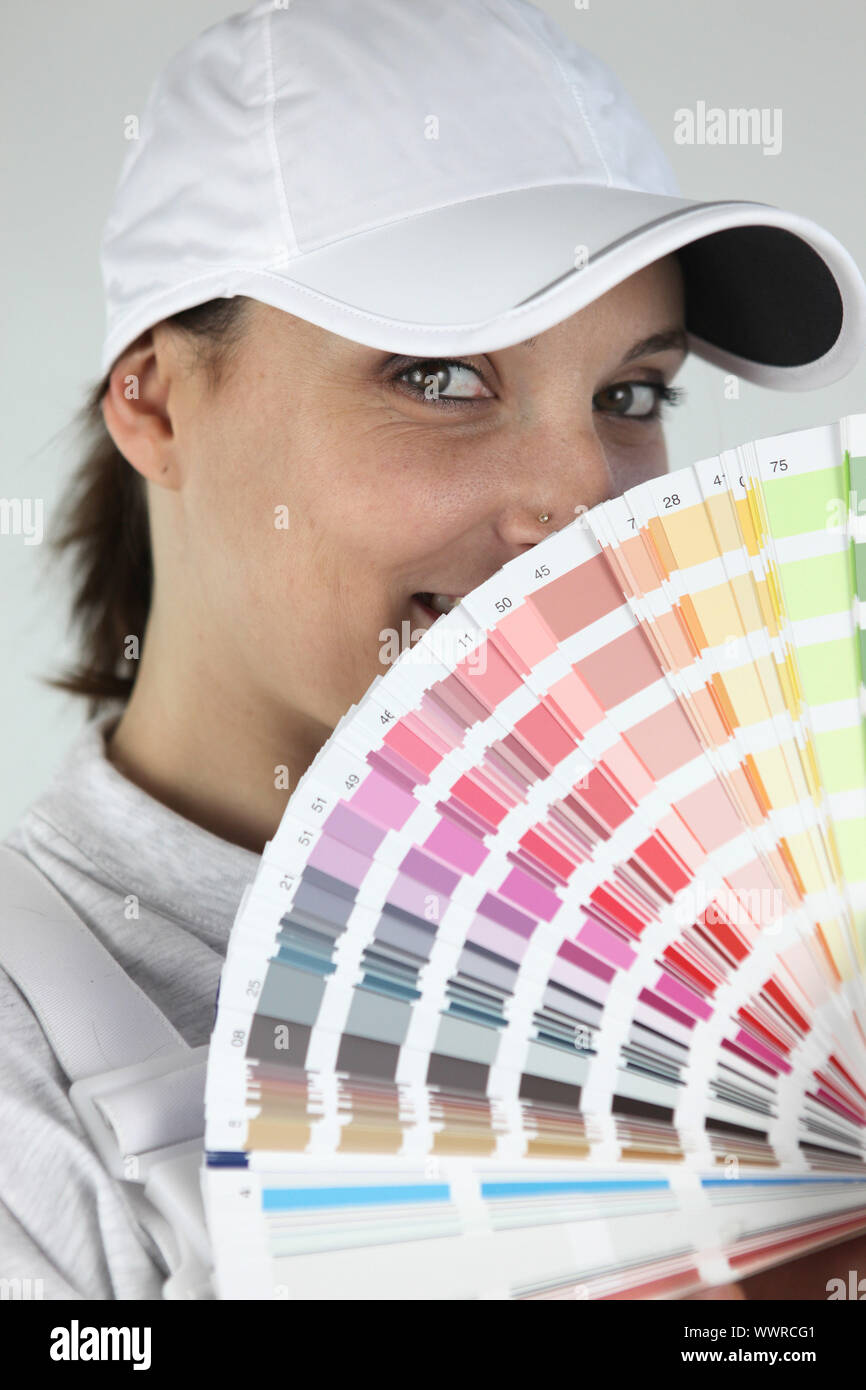 Female decorator choosing color from swatch Stock Photo - Alamy