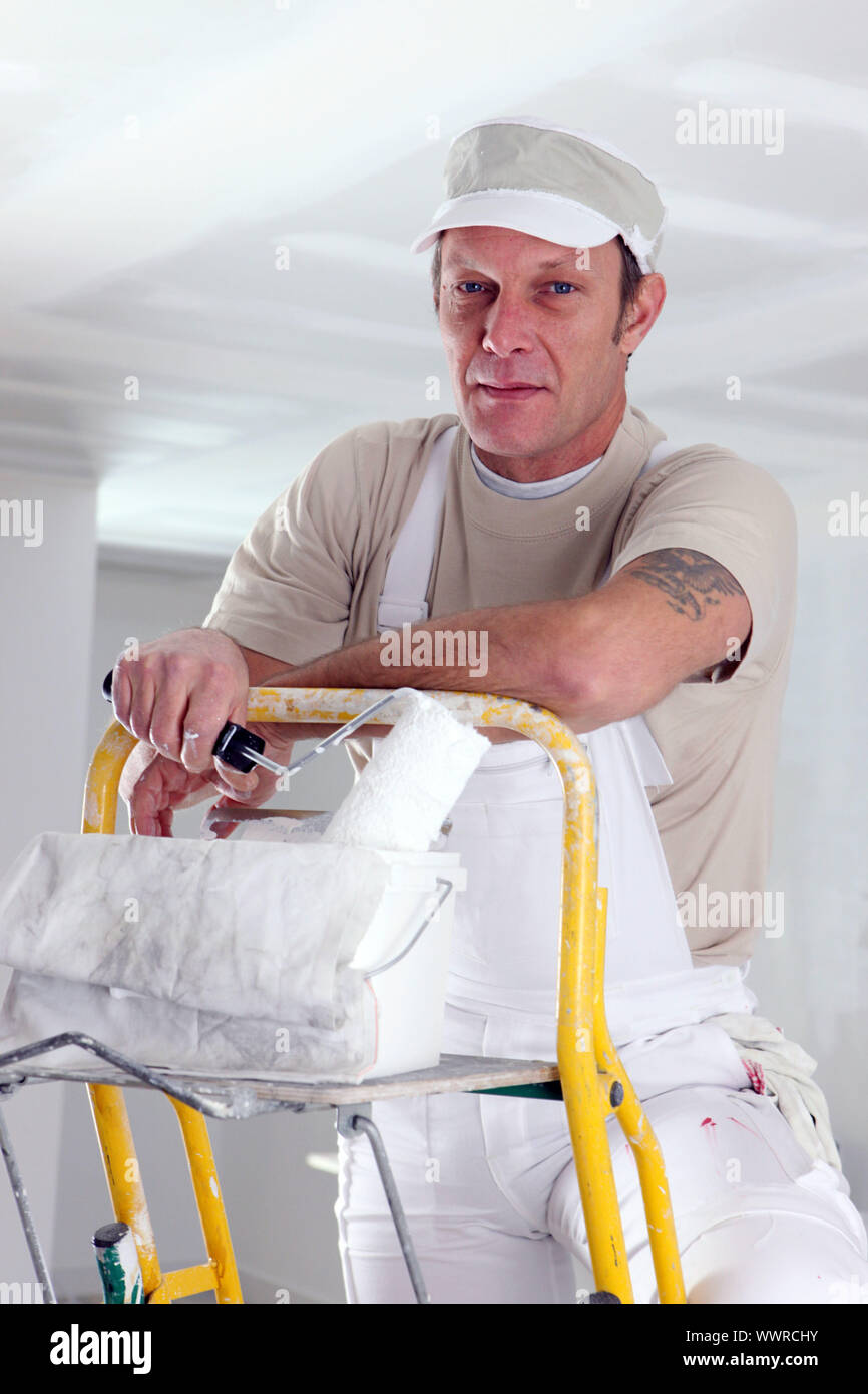 Painter working on ceiling Stock Photo - Alamy