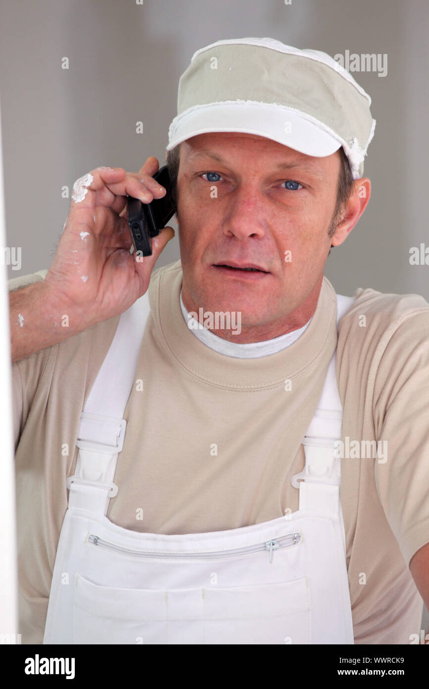 Painter accepting call from customer Stock Photo - Alamy