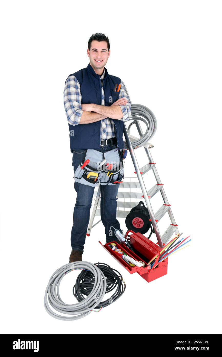 Confident electrician standing on white background Stock Photo - Alamy