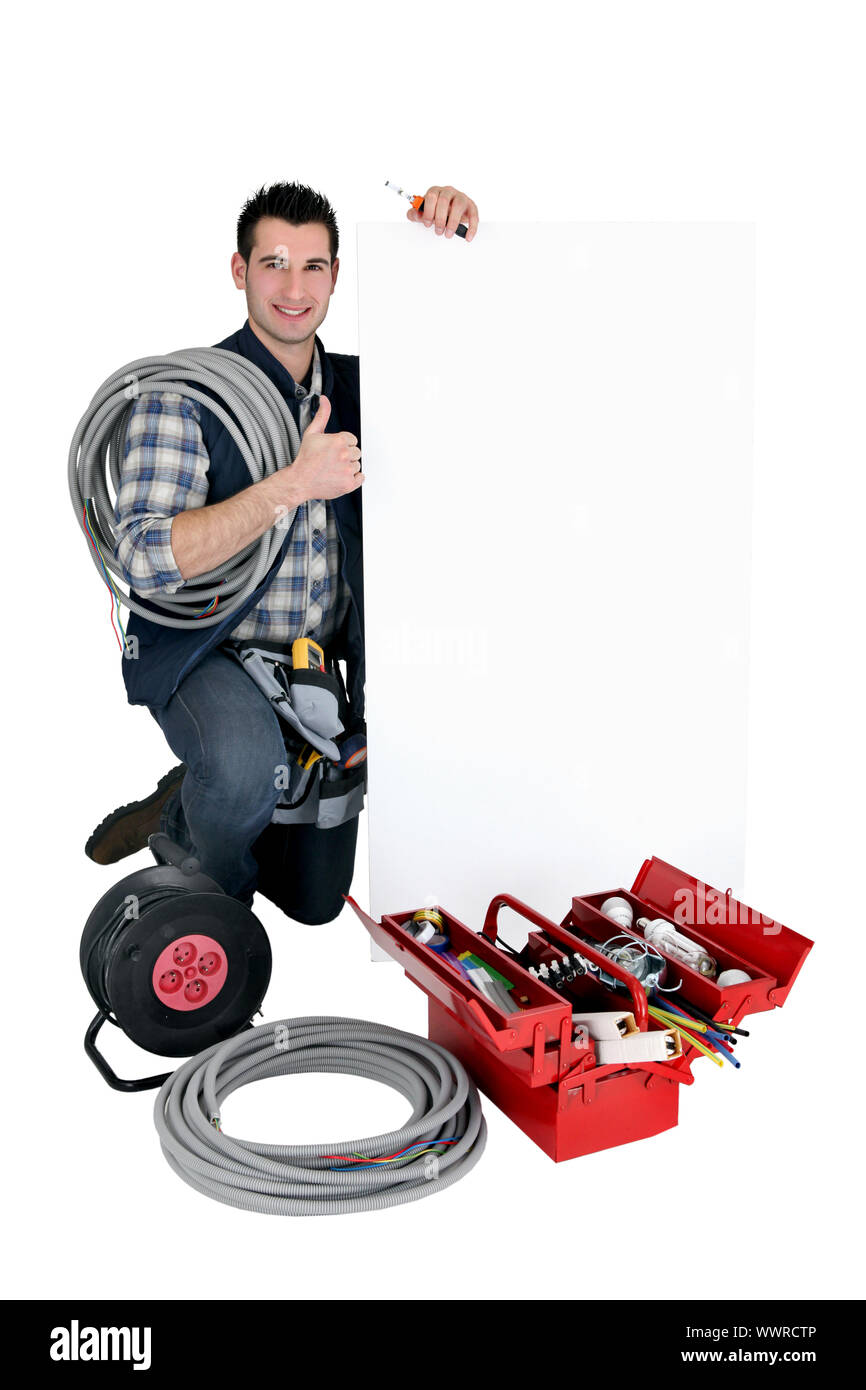 Electrician with white sign Stock Photo - Alamy