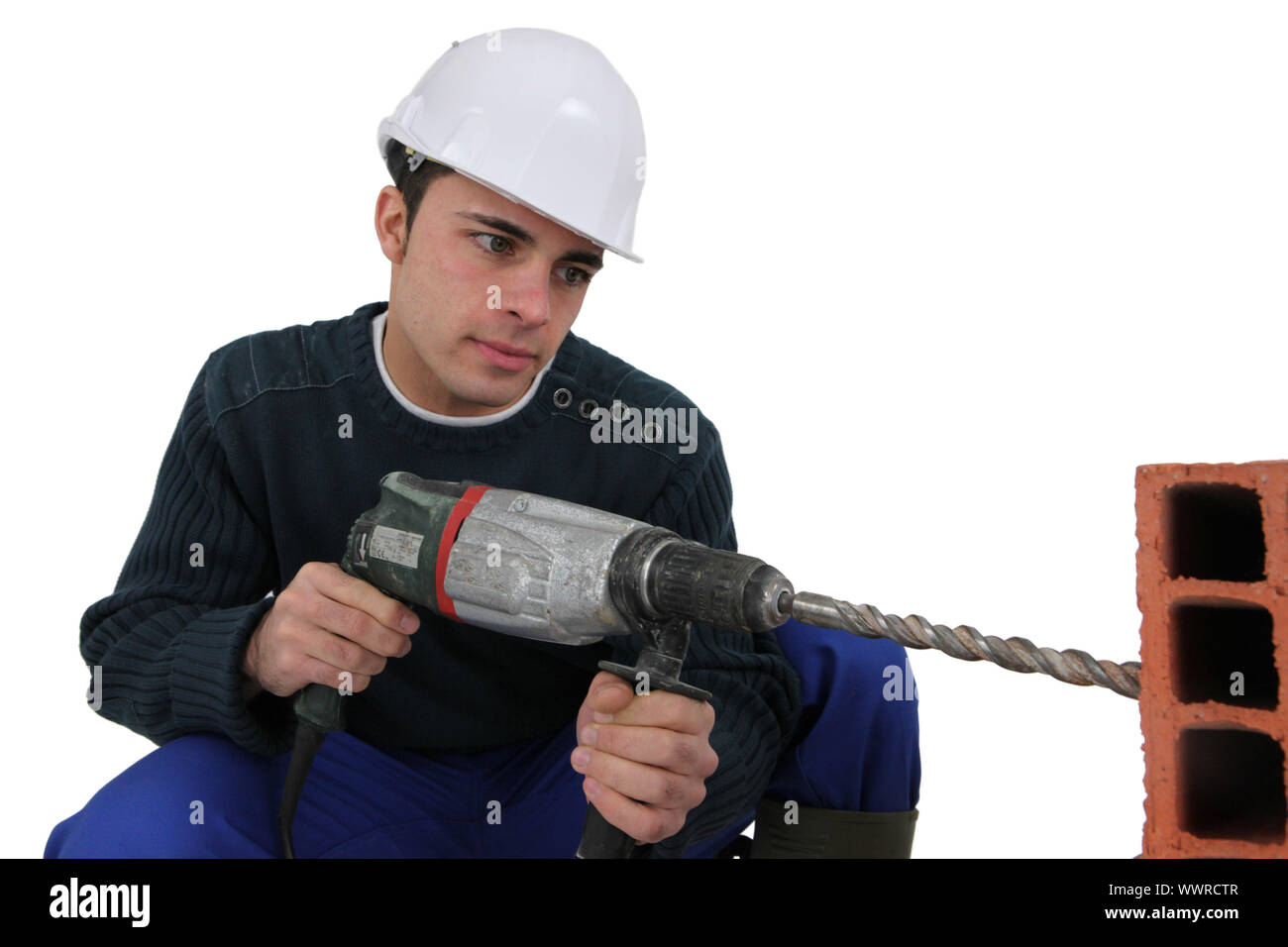 Mason drilling brick Stock Photo - Alamy