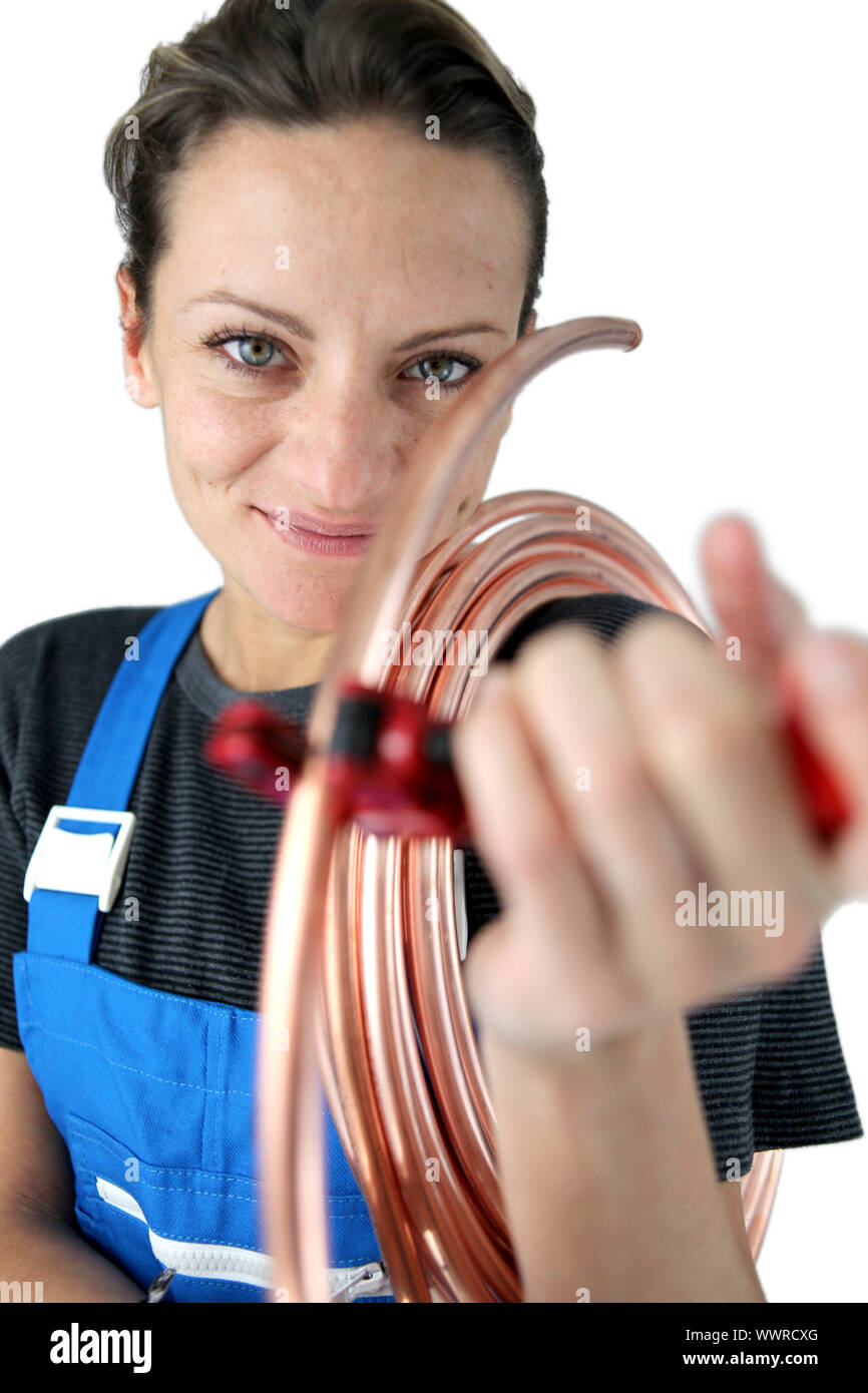 Female plumber cutting copper pipe Stock Photo - Alamy