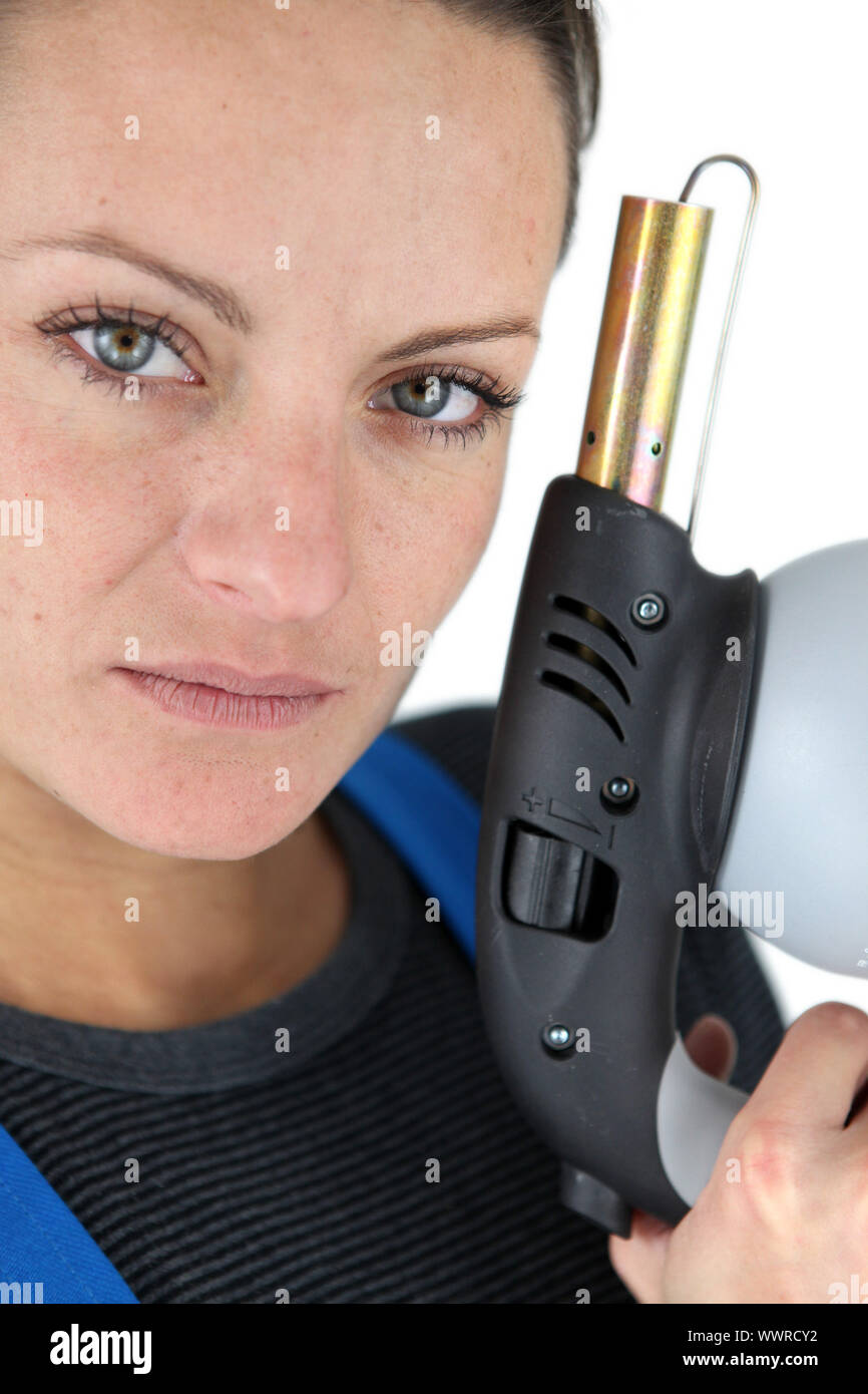Woman holding a blowtorch Stock Photo - Alamy