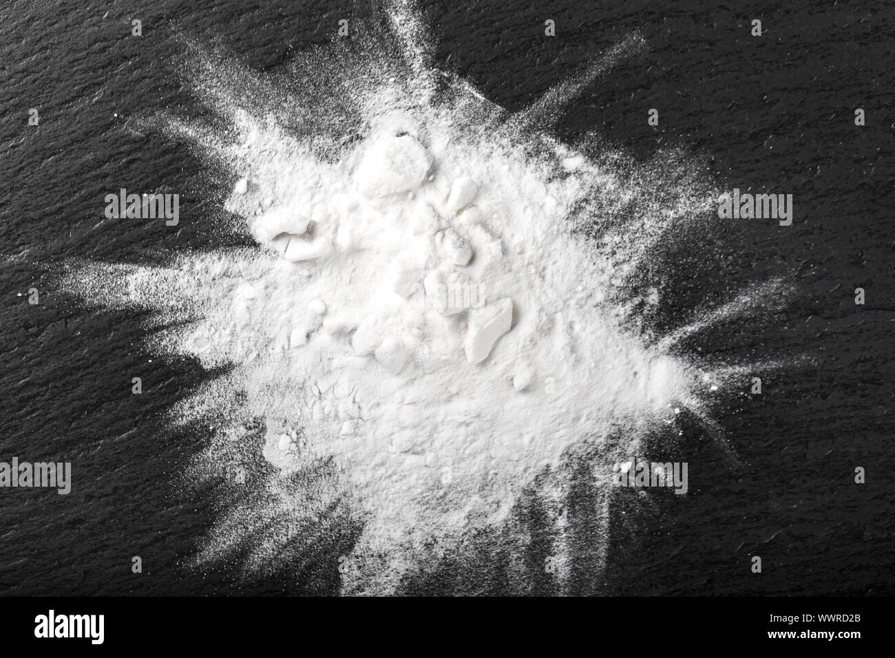 white drug powder scattered on a black table. place for text Stock ...