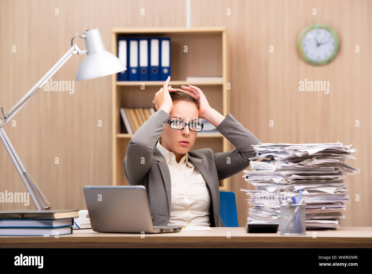Businesswoman under stress in office Stock Photo - Alamy