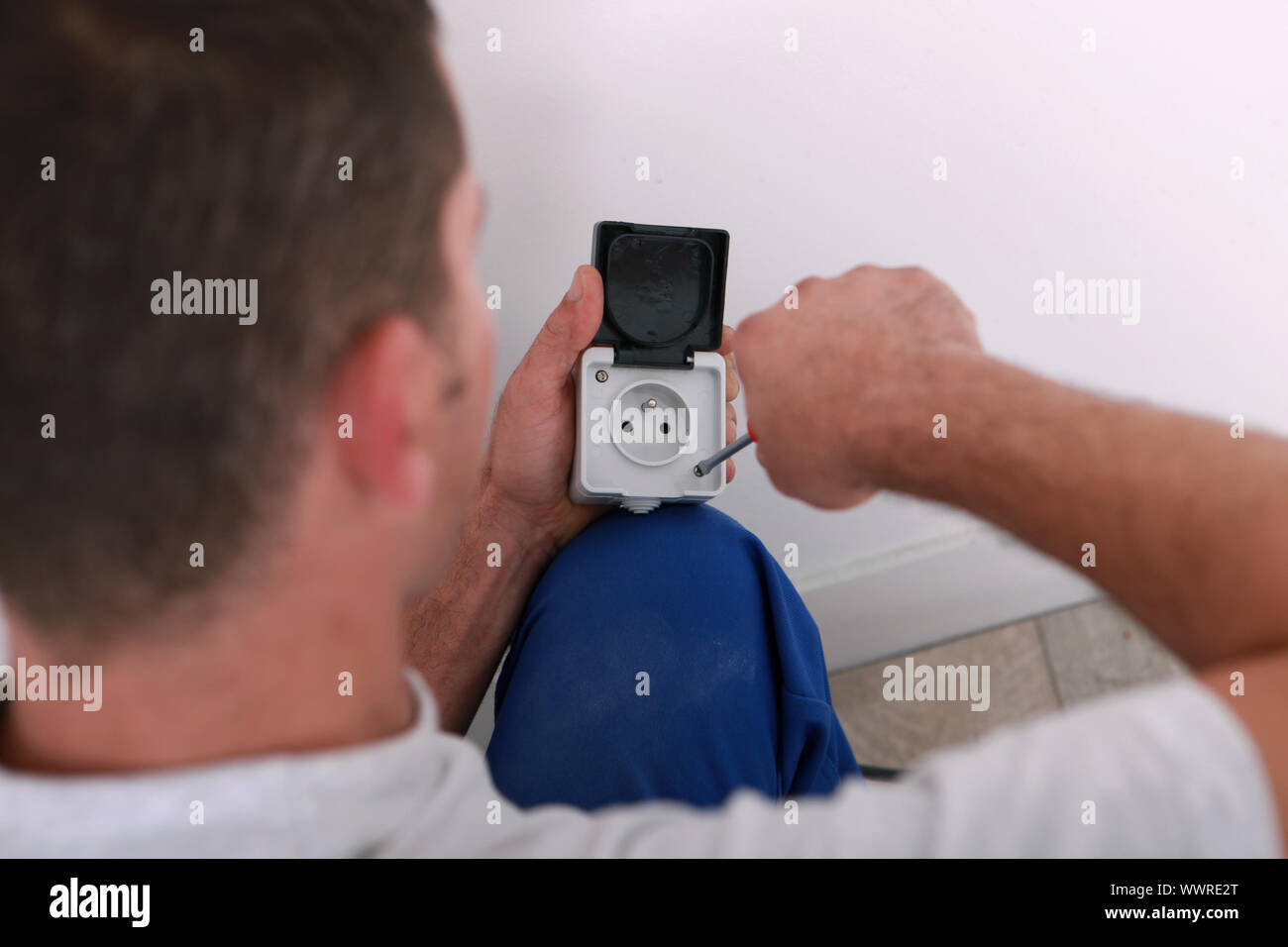 electrician repairing an electricity socket Stock Photo - Alamy