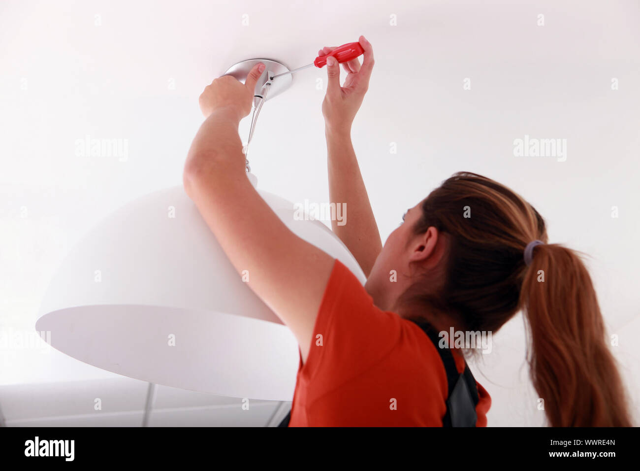 Woman placing lamp hi-res stock photography and images - Alamy