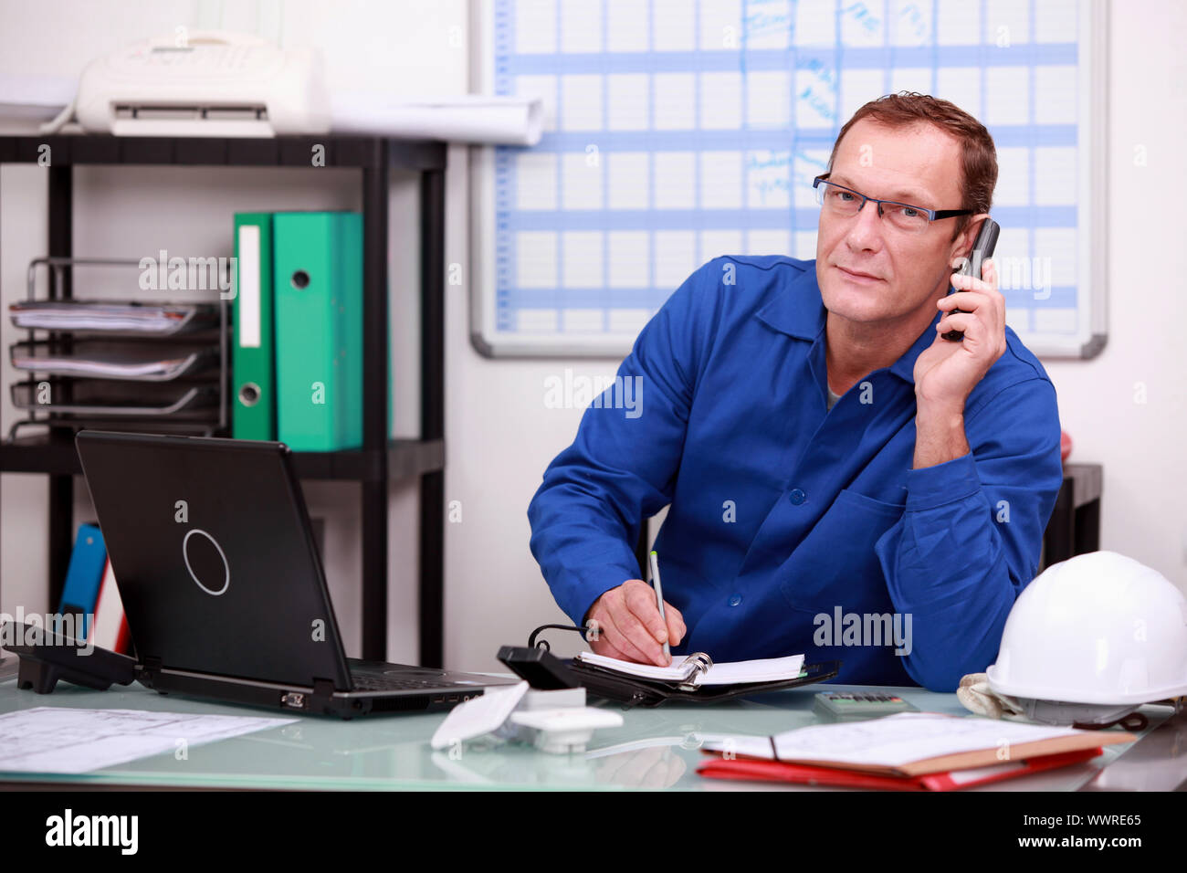 Construction worker ordering building materials Stock Photo - Alamy