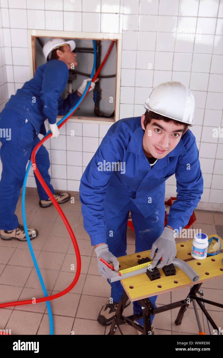 Plumbers at work Stock Photo - Alamy