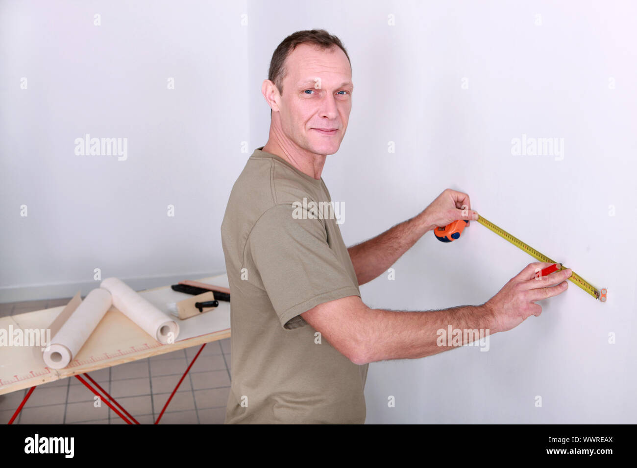 Man measuring wall Stock Photo - Alamy
