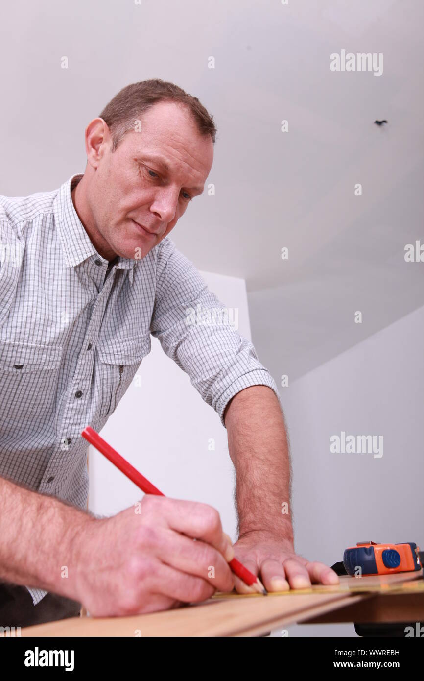 Carpenter marking a piece of wood Stock Photo - Alamy