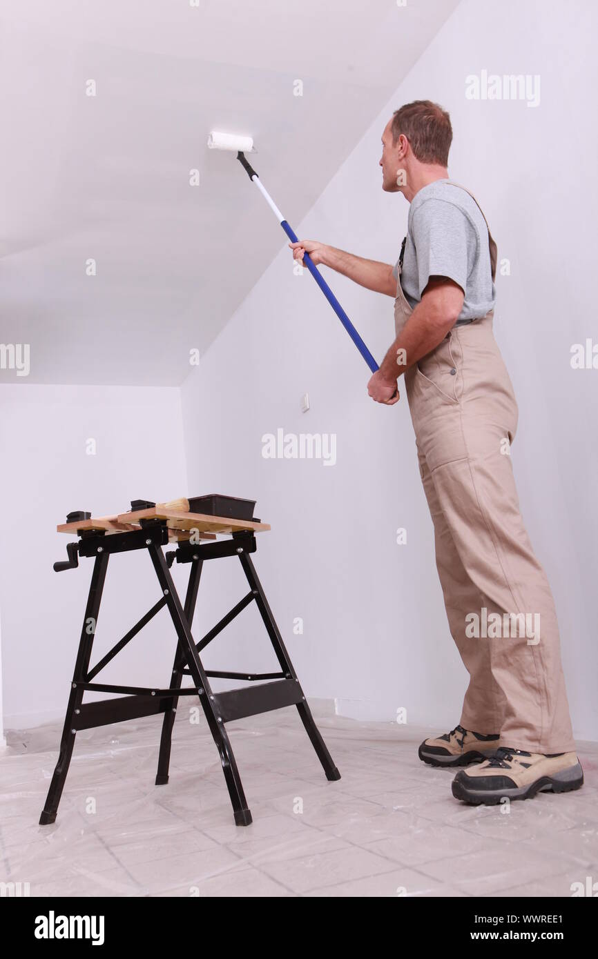 Man painting ceiling Stock Photo - Alamy
