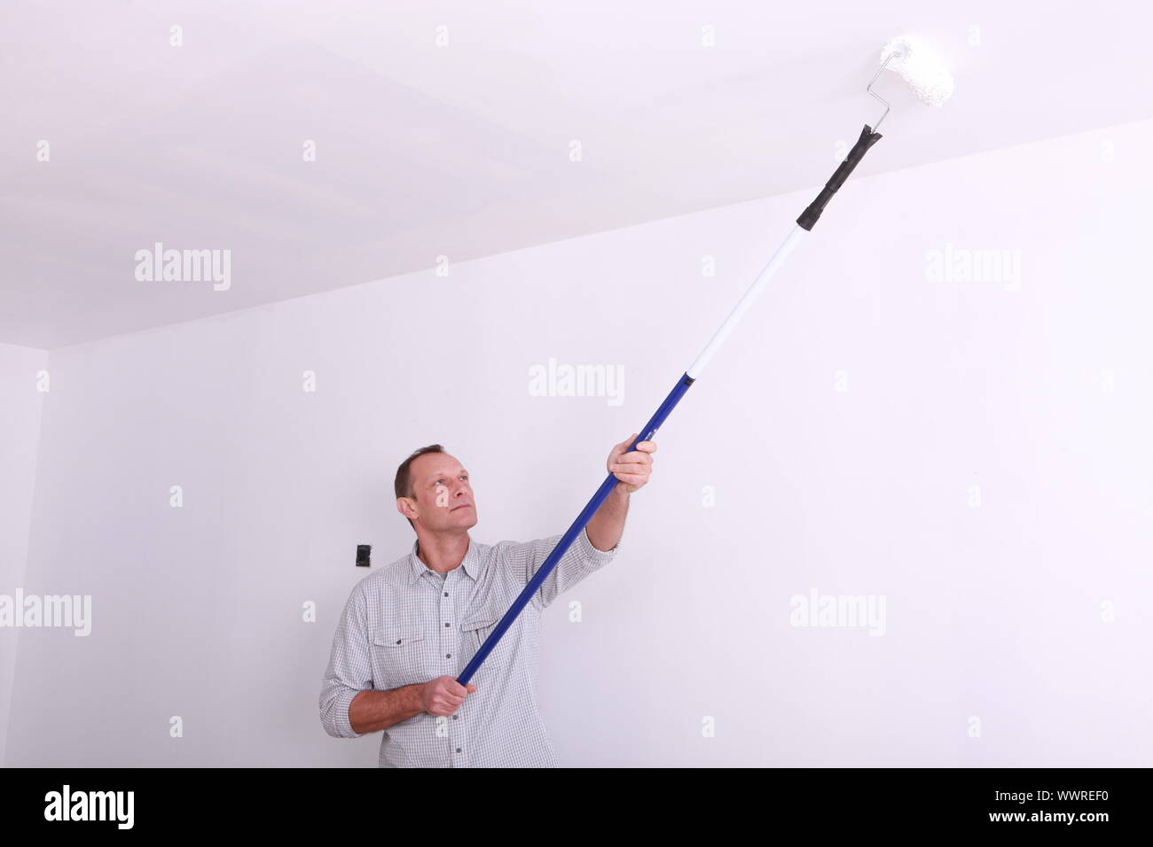 Man painting ceiling Stock Photo - Alamy