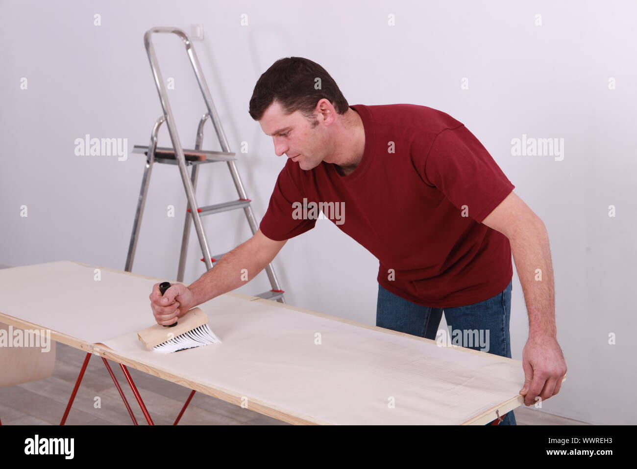 Man gluing wallpaper Stock Photo - Alamy