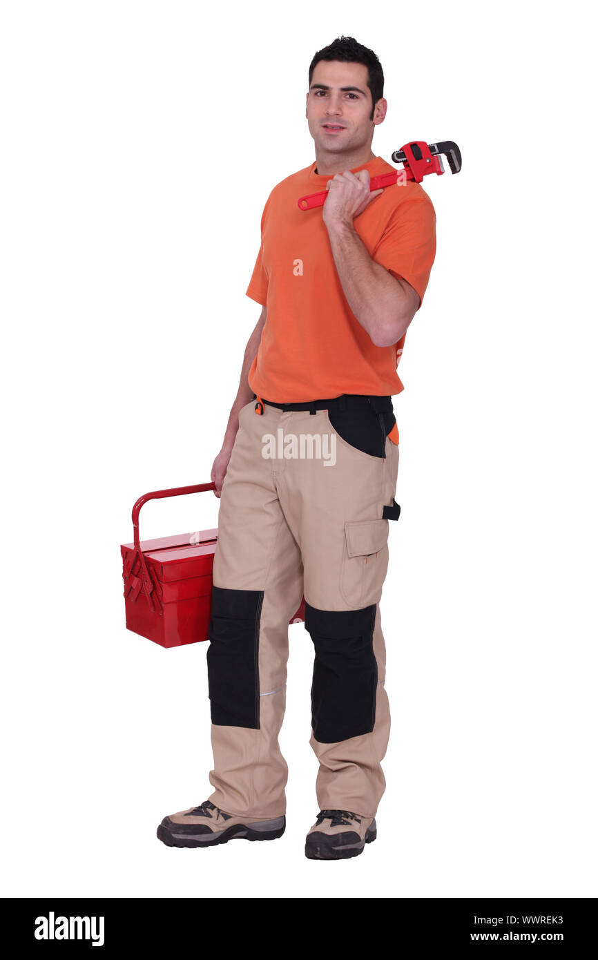 Handyman stood with wrench and tool kit Stock Photo - Alamy