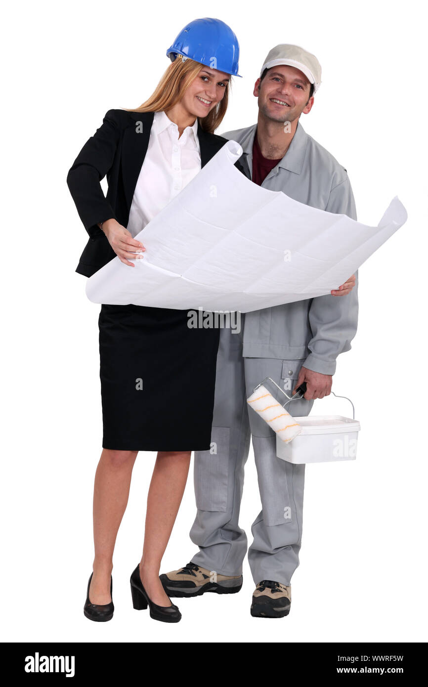 Architect stood explaining designs to decorator Stock Photo - Alamy