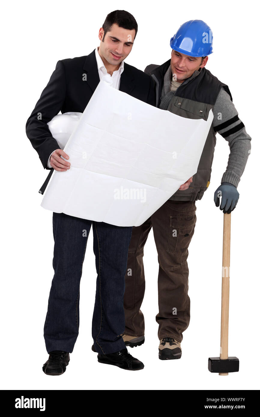 Architect and construction worker looking at plans Stock Photo - Alamy