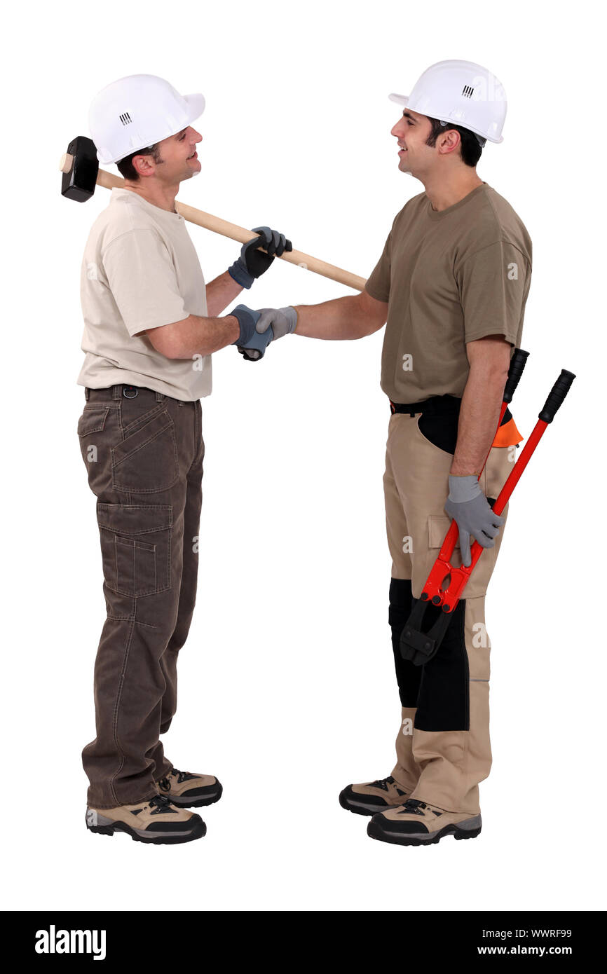 Two manual worker shaking hands Stock Photo - Alamy