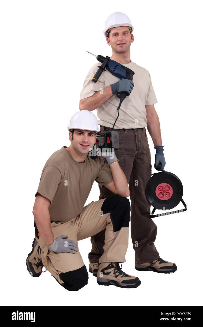 two craftsmen working with drills Stock Photo - Alamy