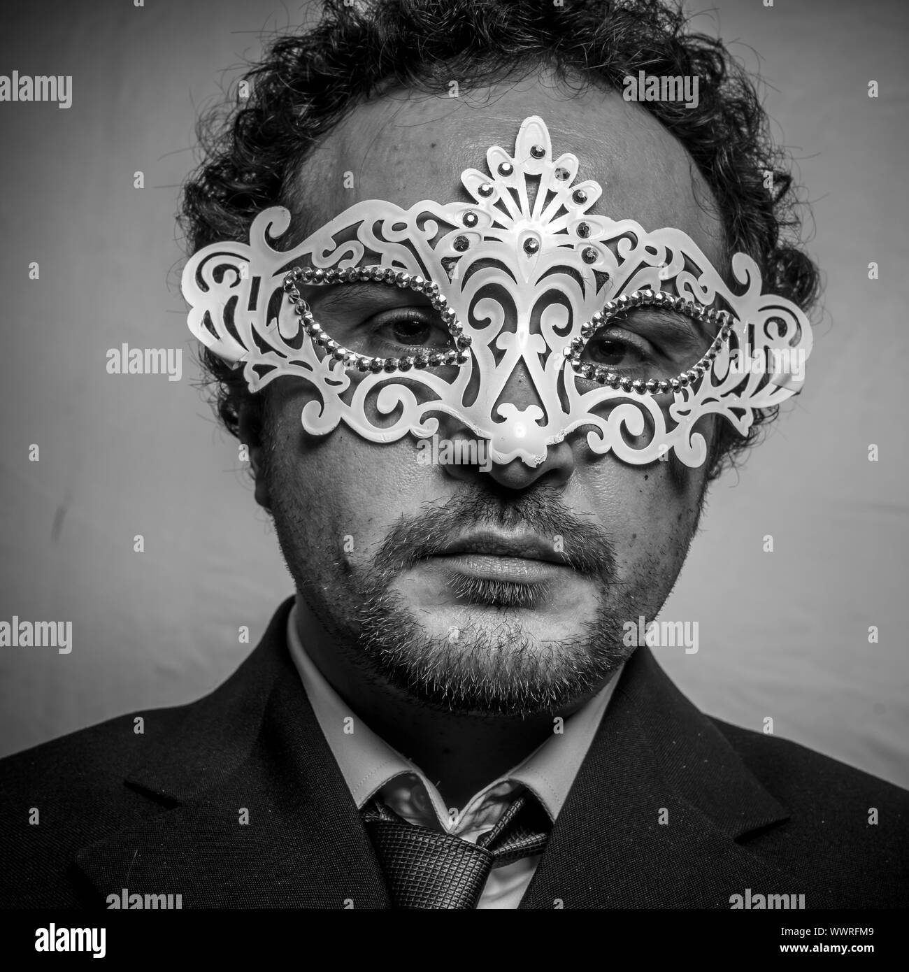 Hypocrisy, Sensual and mysterious businessman with white venetian mask ...