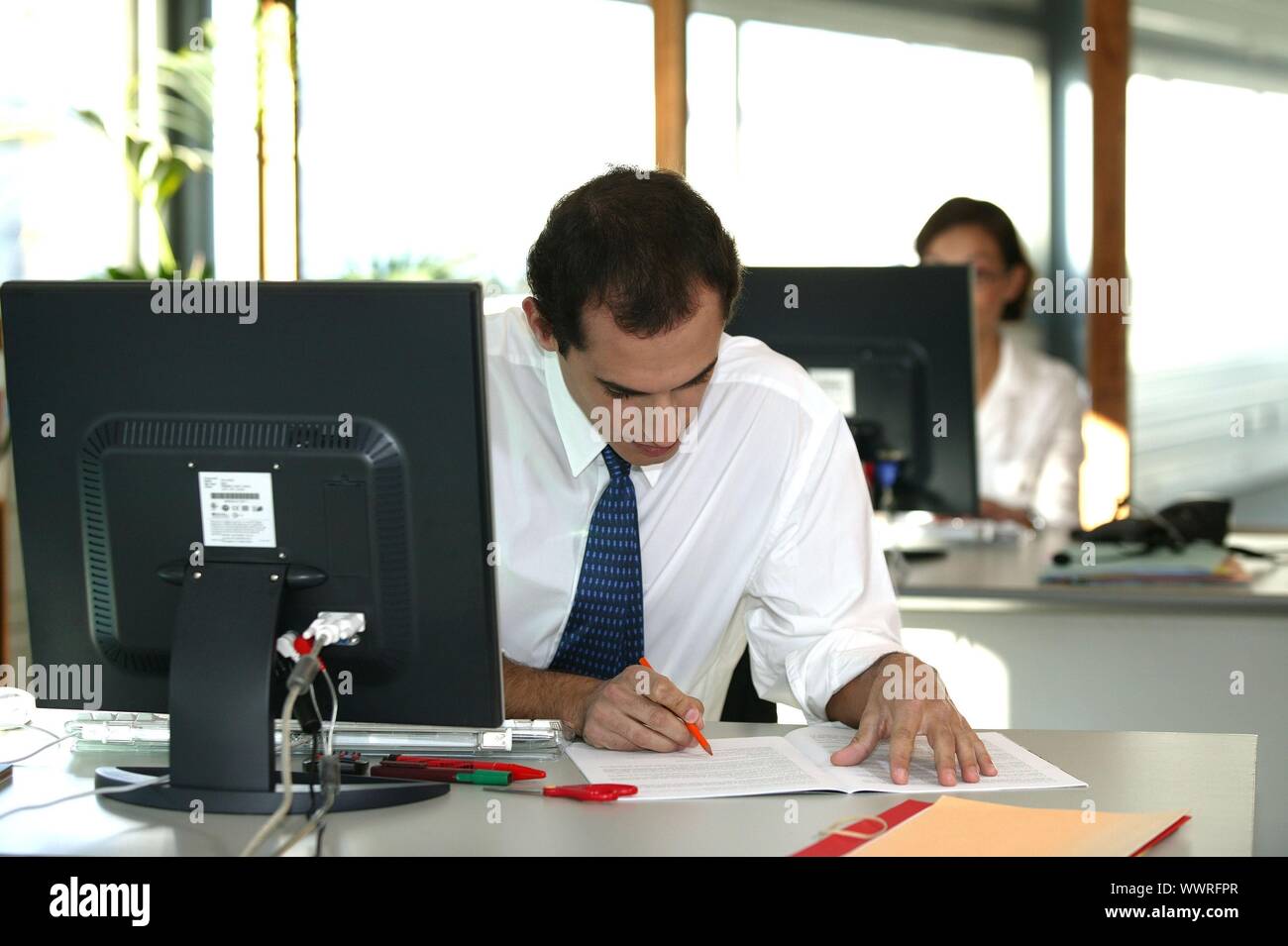 Office worker reviewing a file Stock Photo - Alamy